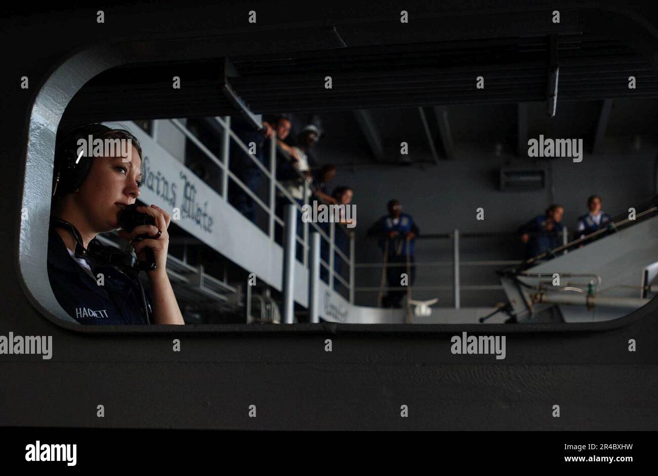US Navy Seaman communicates via sound powered telephone as deck ...