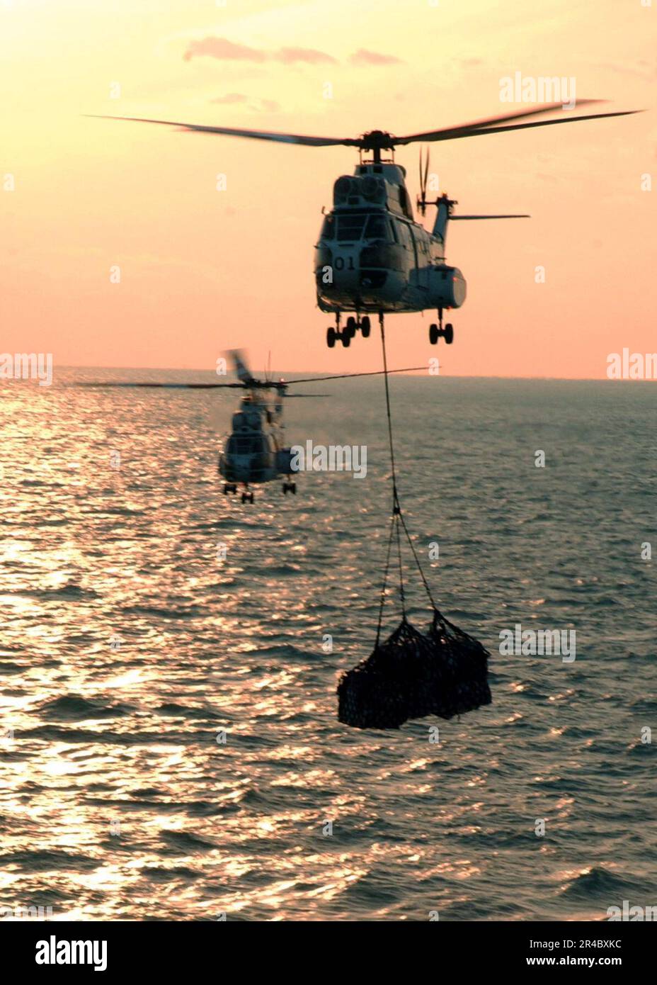US Navy Two SA-330 Puma helicopters deliver supplies to the Nimitz-class aircraft carrier USS ...