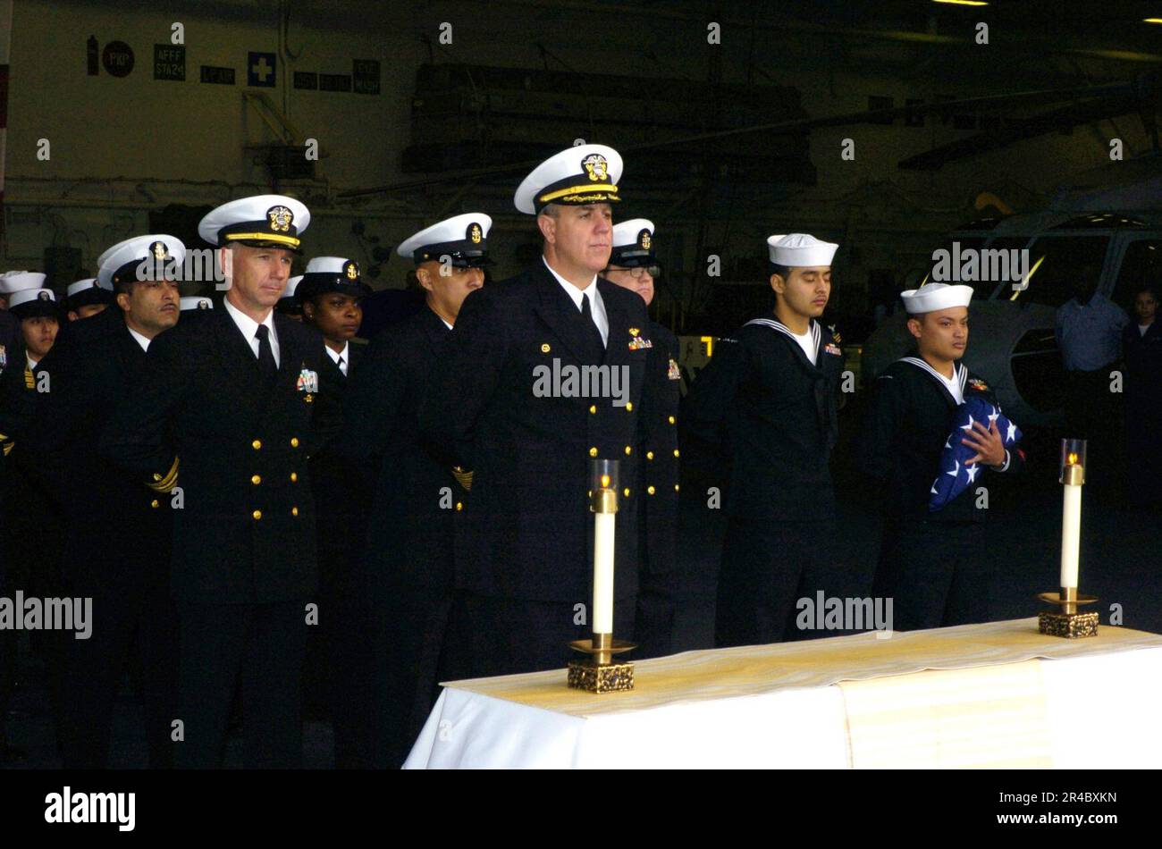 US Navy Capt. leads the ceremonial detail for the burial at sea for the ...