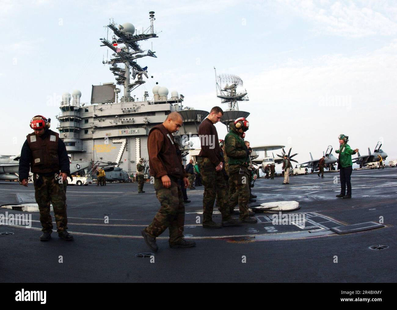 US Navy Flight deck personnel participate in a foreign object debris ...