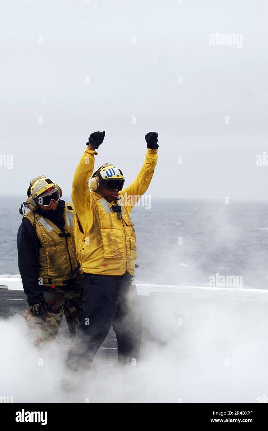 US Navy A plane director signals the pilot to break Stock Photo - Alamy