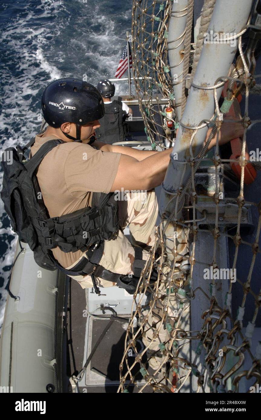 US Navy Boatswain's Mate 3rd Class climbs down to a Rigid Hull ...