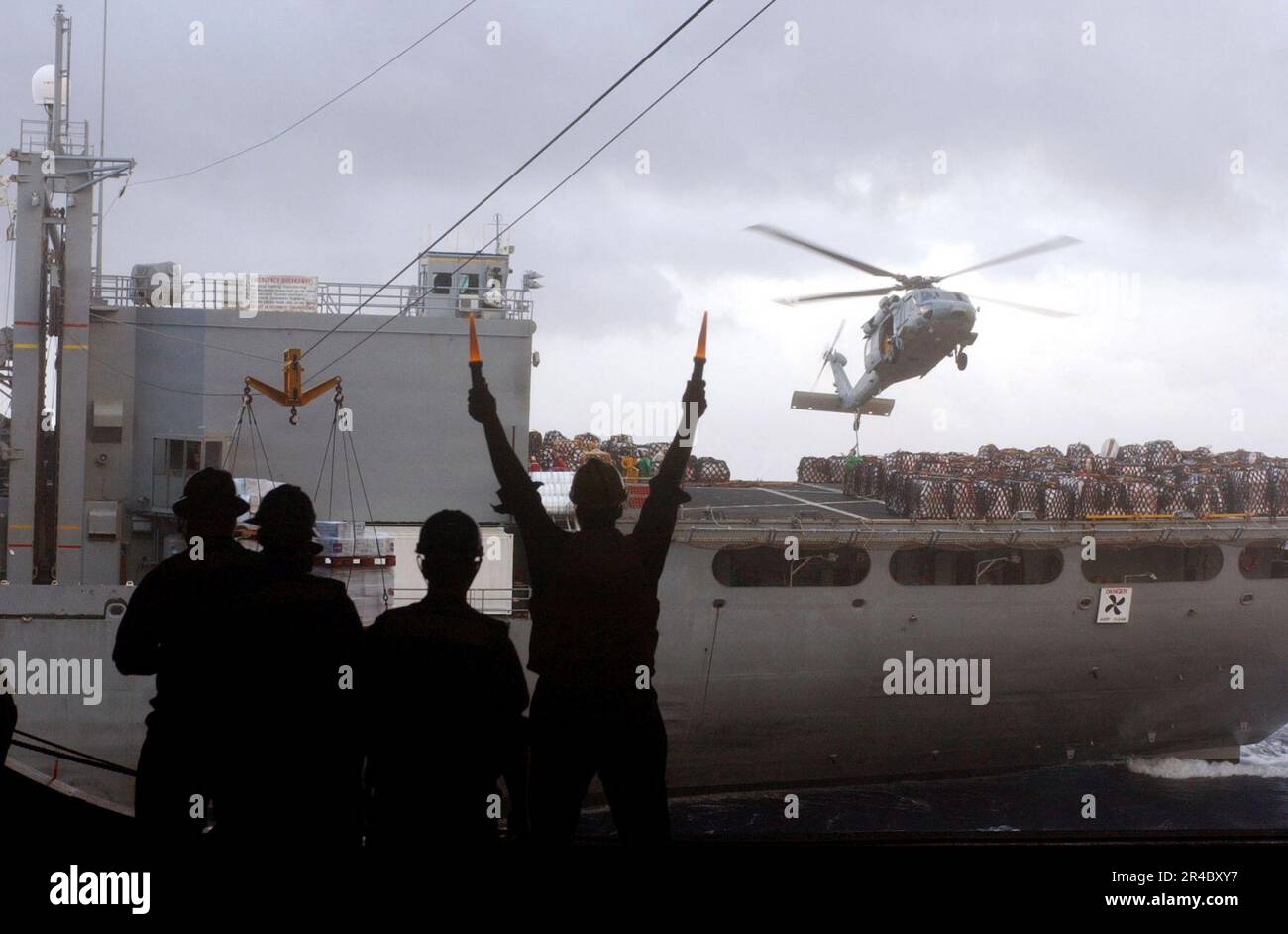 US Navy Boatswain's mates wait for stores to be delivered to the Nimitz ...