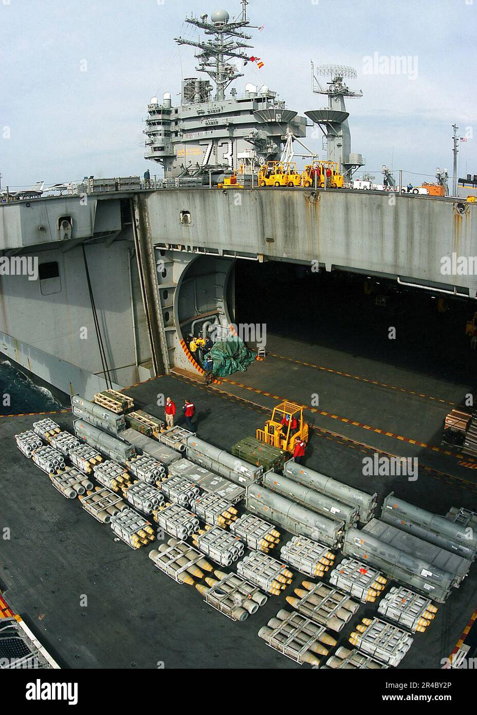 US Navy Ammunition is transferred from the flight deck to the ship's ...