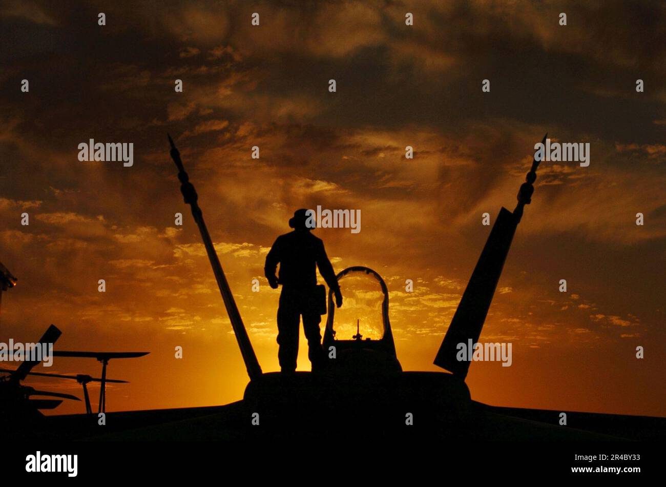 US Navy A plane captain conducts a post flight inspection on a F-A-18 ...