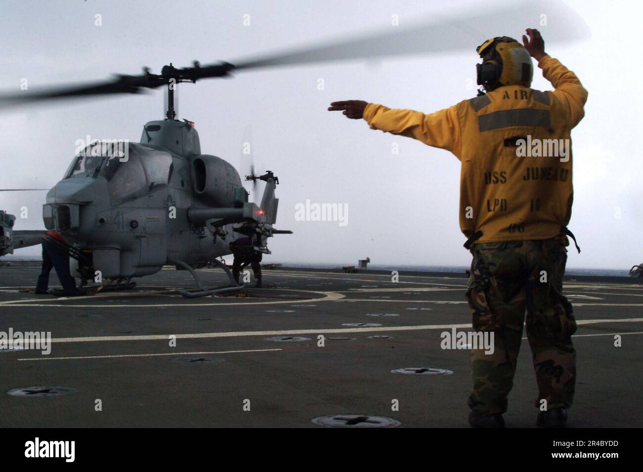 US Navy Aviation Support Equipment Technician 1st Class acts as landing ...