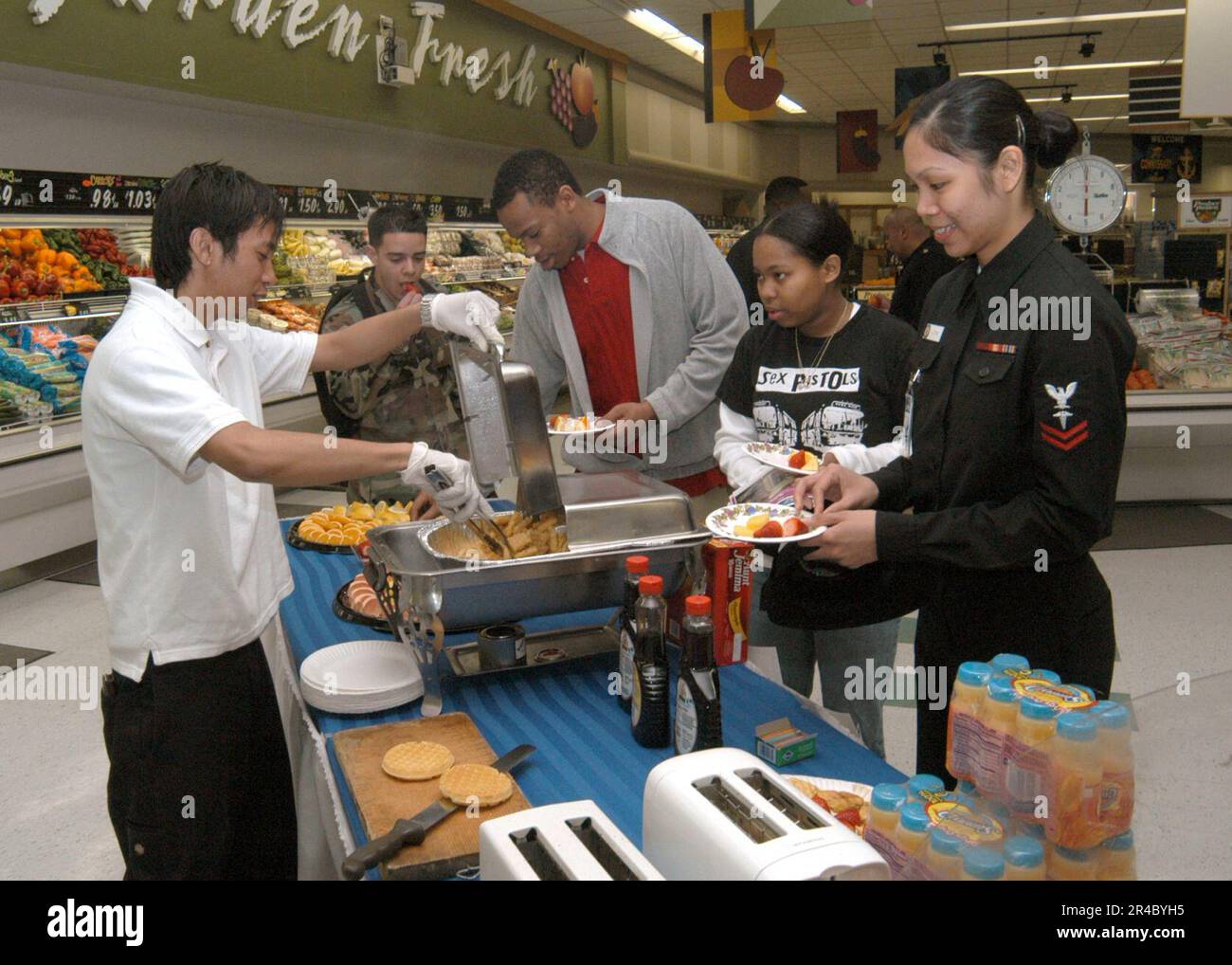 US Navy Sailors enjoy free samples of various breakfast items during ...