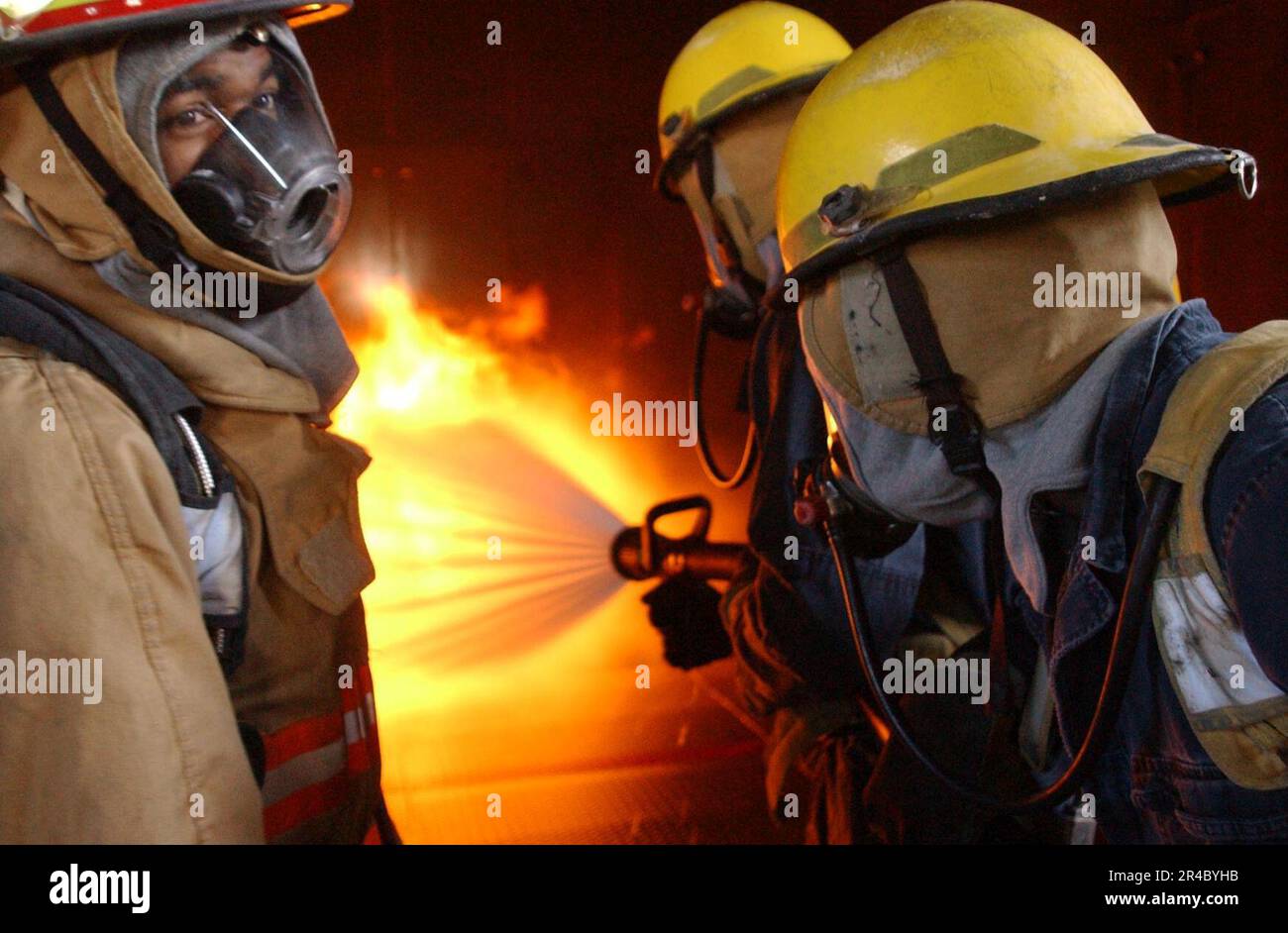 US Navy Machinist's Mate 1st Class looks on as his students apply newly ...