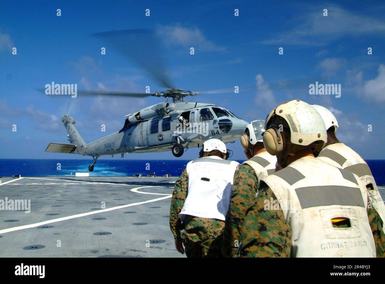 US Navy Combat Cargo Marines brace themselves as an MH-60S Seahawk ...