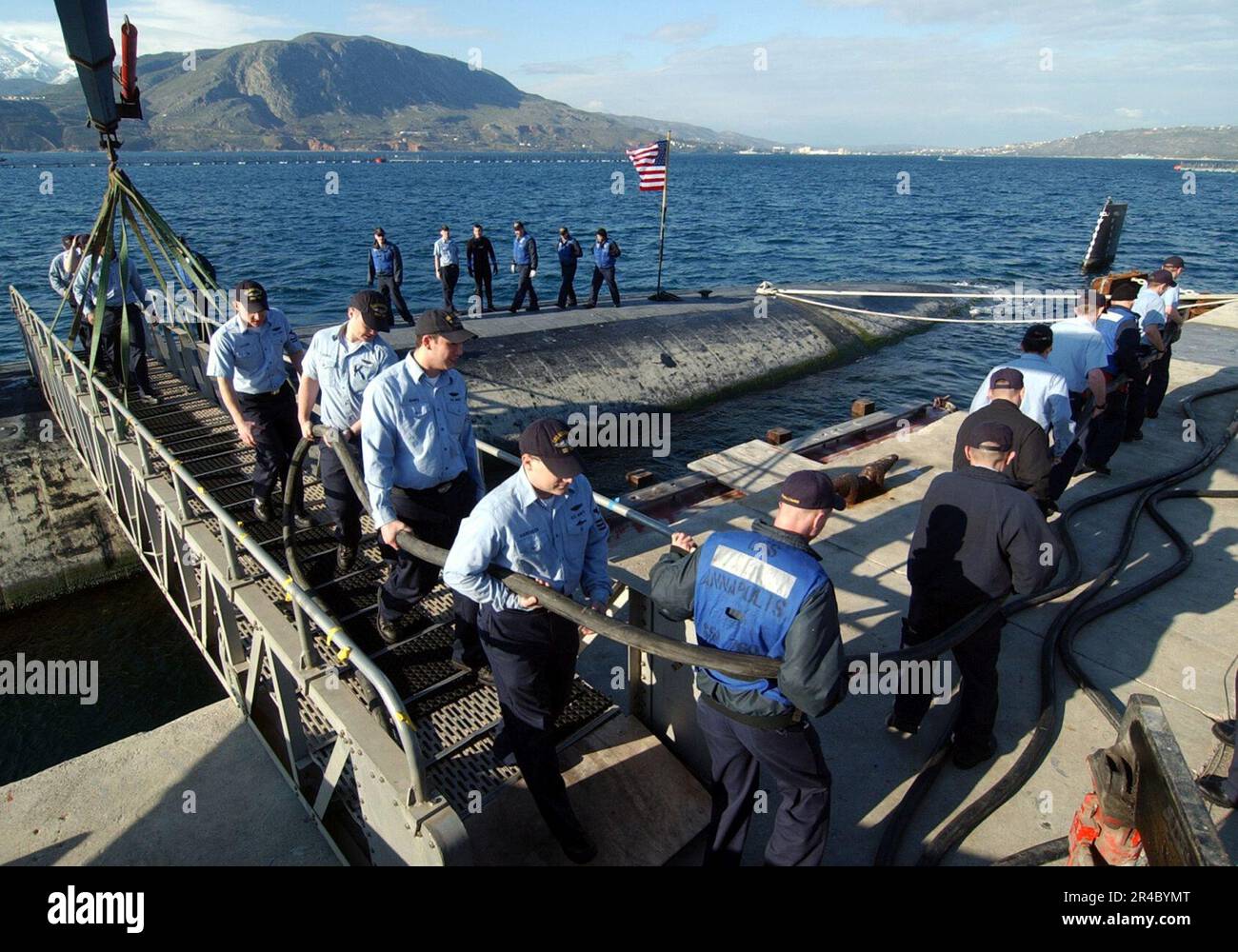US Navy Crew members remove a shore power cable from the Los Angeles ...