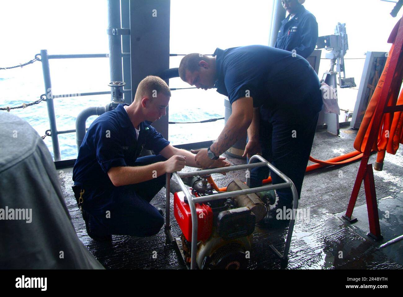US Navy Damage Controlman test a P-100 portable pump aboard the ...