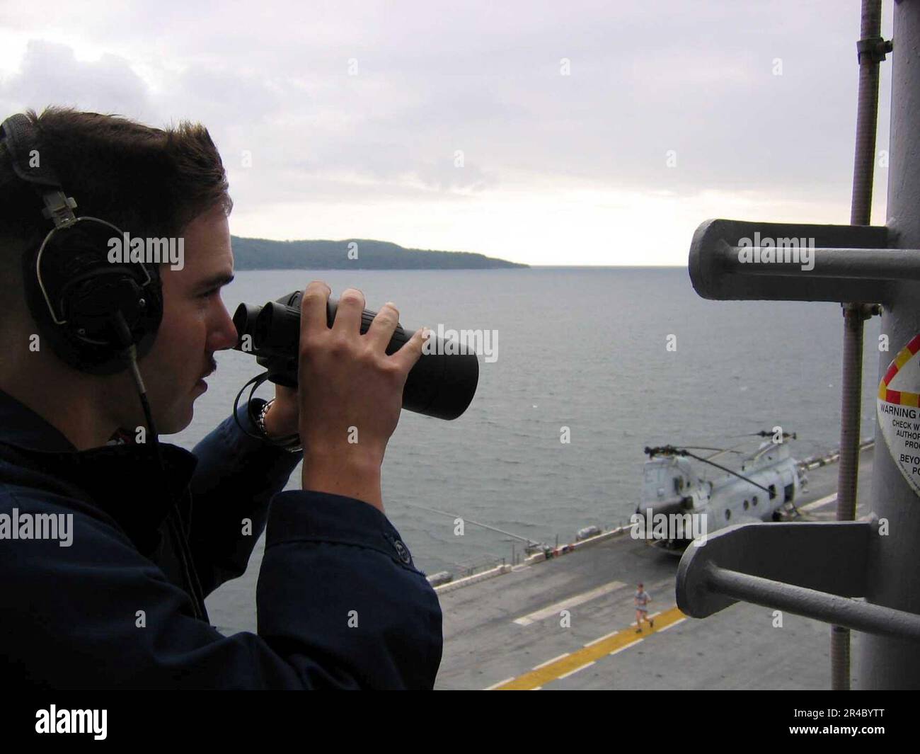 US Navy Operations Specialist 3rd Class stands watch on the signal ...