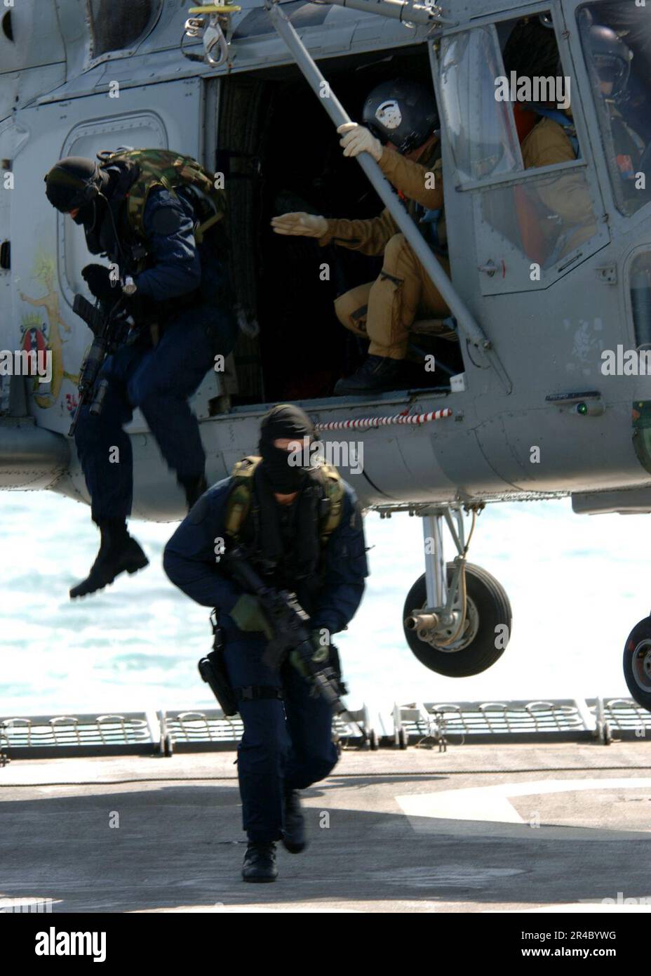 US Navy Dutch Marines exit a helicopter during a visit, board, search ...