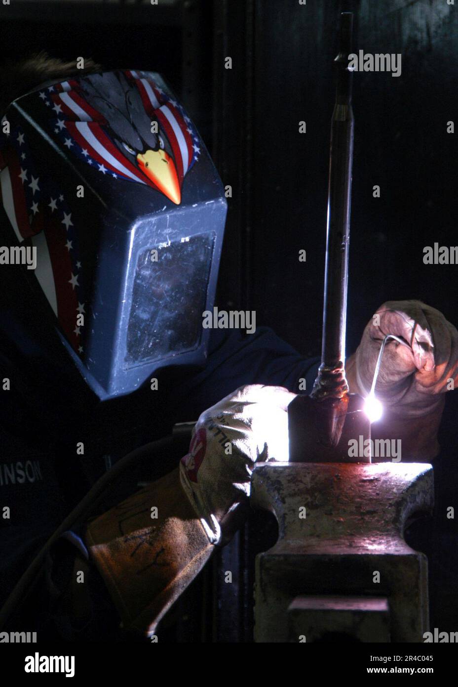 US Navy Hull Maintenance Technician 2nd Class repairs a pnuematic air ...