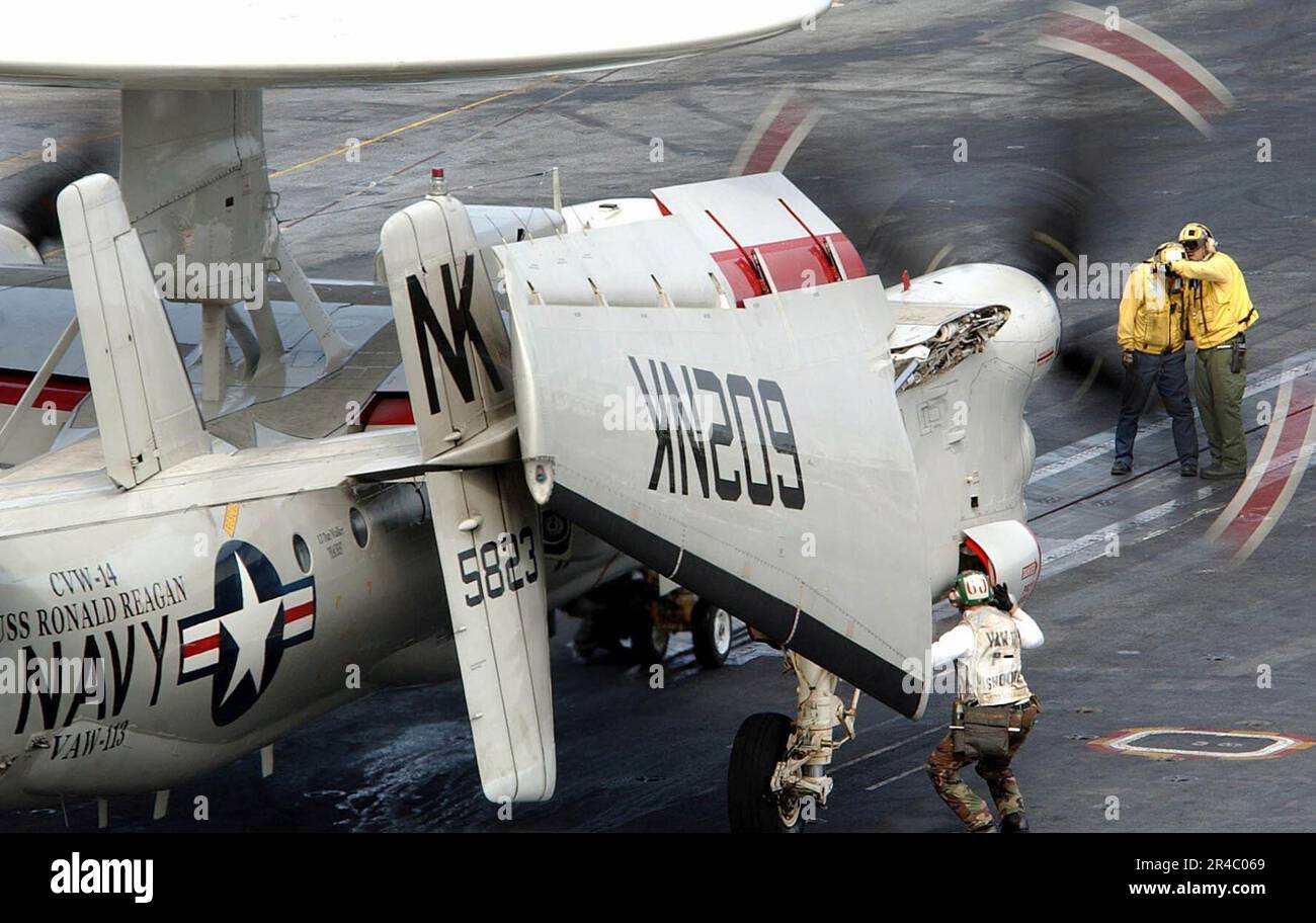 US Navy Flight deck personnel perform a final pre-flight check of an E ...
