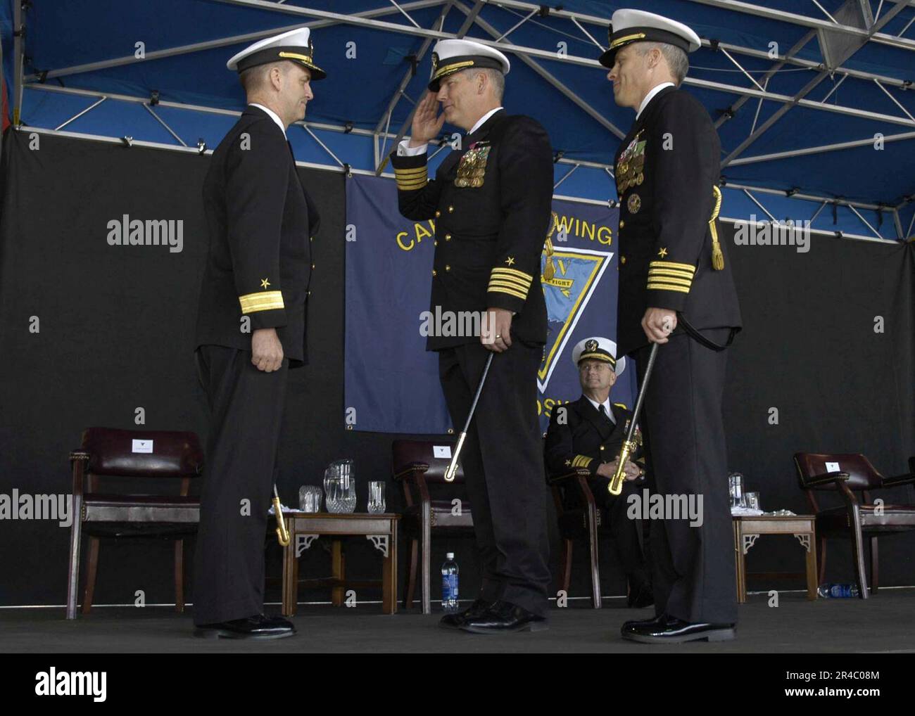 US Navy Capt. renders a salute to Rear Adm. John W. Goodwin as he is ...
