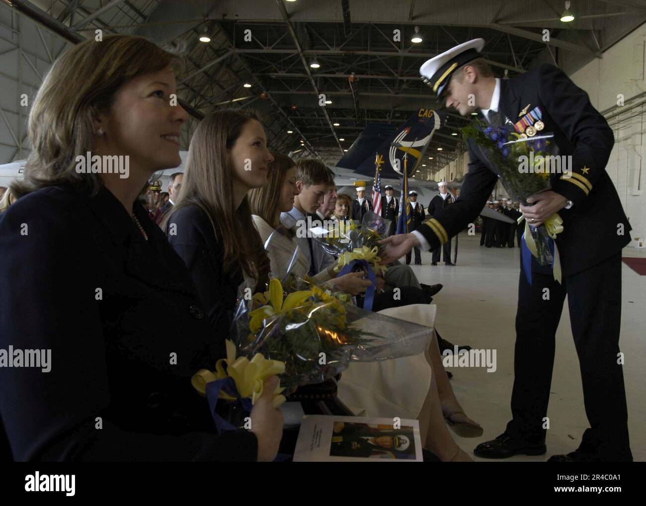 US Navy Capt. Family members receive flowers during the change of ...