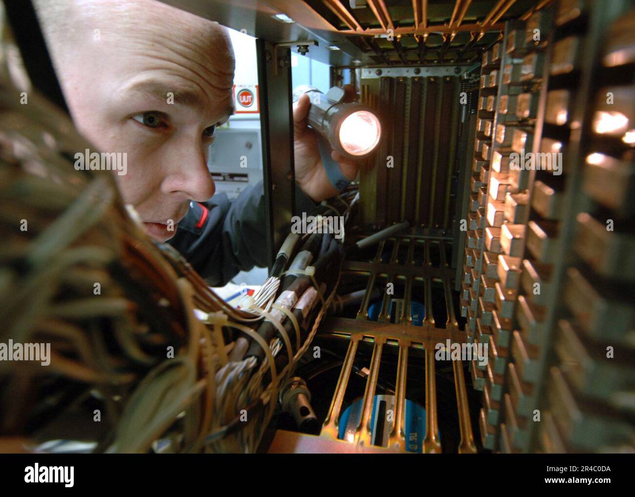 US Navy Aviation Electronics Technician 3rd Class inspects a ...