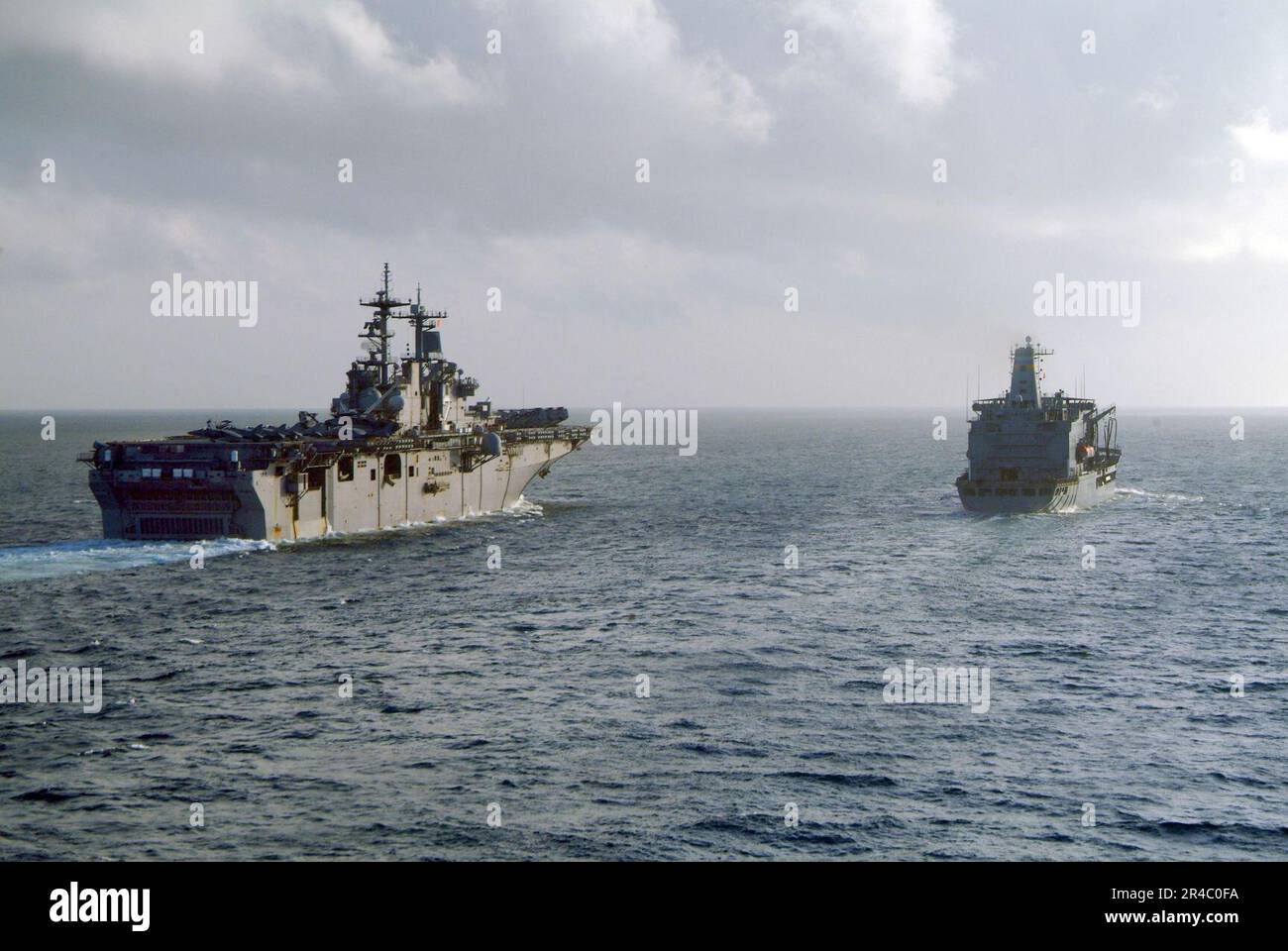 US Navy The amphibious assault ship USS Essex (LHD 2), left, navigates ...
