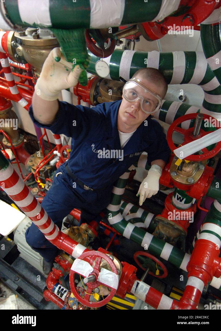 US Navy Damage Controlman Fireman paints a High Capacity Aqueous Film ...