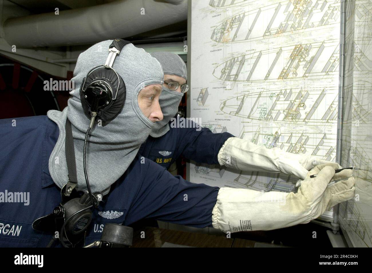 US Navy The Repair Locker Leader instructs a sailor on how to plot ...