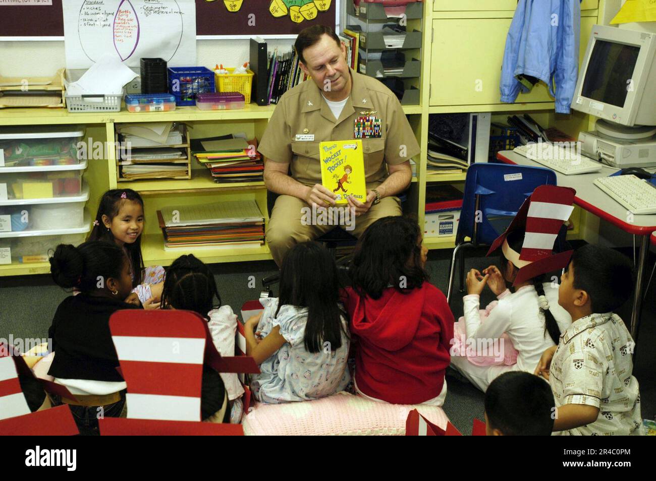 US Navy USS Kitty Hawk (CV 63) Commanding Officer, Capt. reads a Dr ...