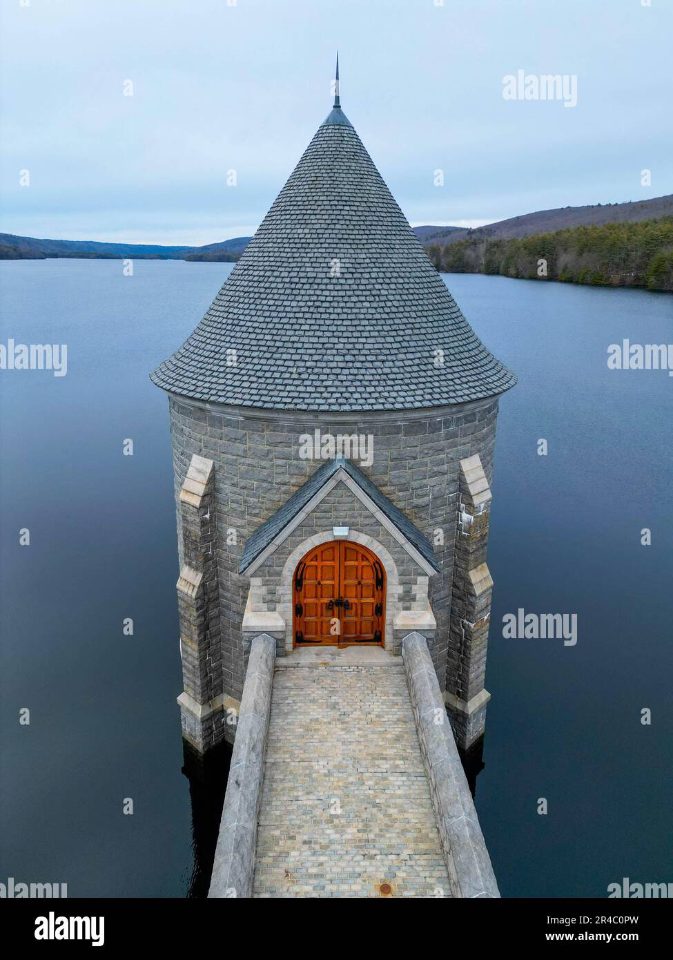 An ancient castle situated by a tranquil lake, featuring a wooden dock ...