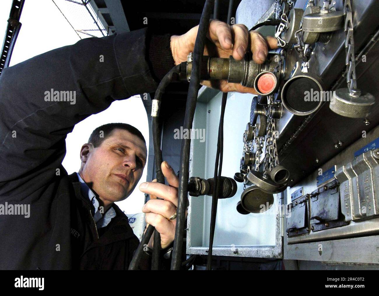 US Navy Aviation Machinist's Mate 1st Class connects power and sensor ...