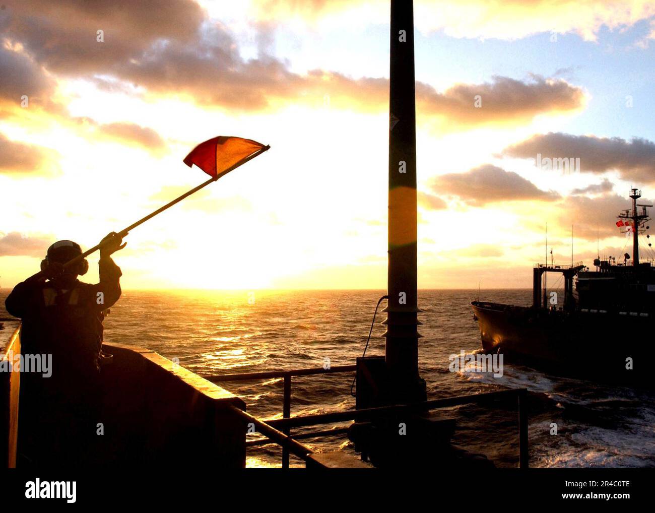 US Navy Using the Oscar flag, a sailor aboard the combat stores ship ...