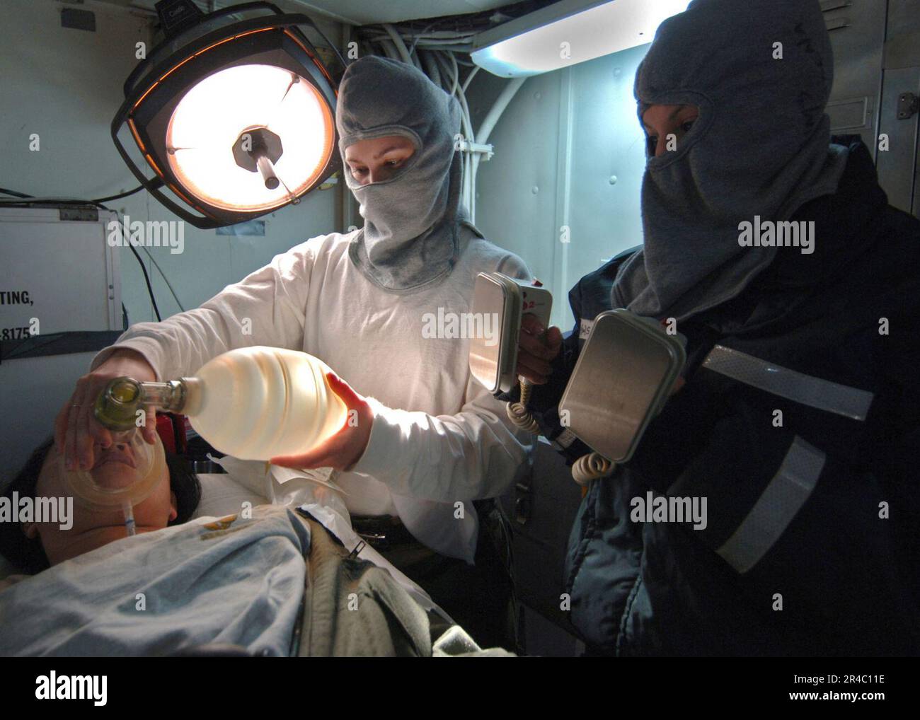 US Navy Hospital Corpsman 3rd Class provides rescue breathing, while ...