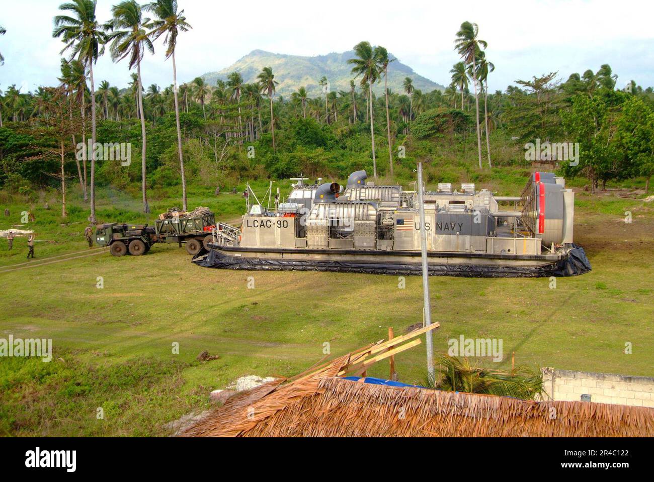 US Navy Marines assigned to the 31st Marine Service Support Group (MSSG) load equipment on a ...