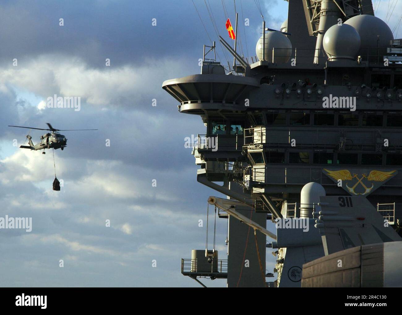US Navy An HH-60H Seahawk helicopter prepares to deliver a load of cargo to the flight deck ...