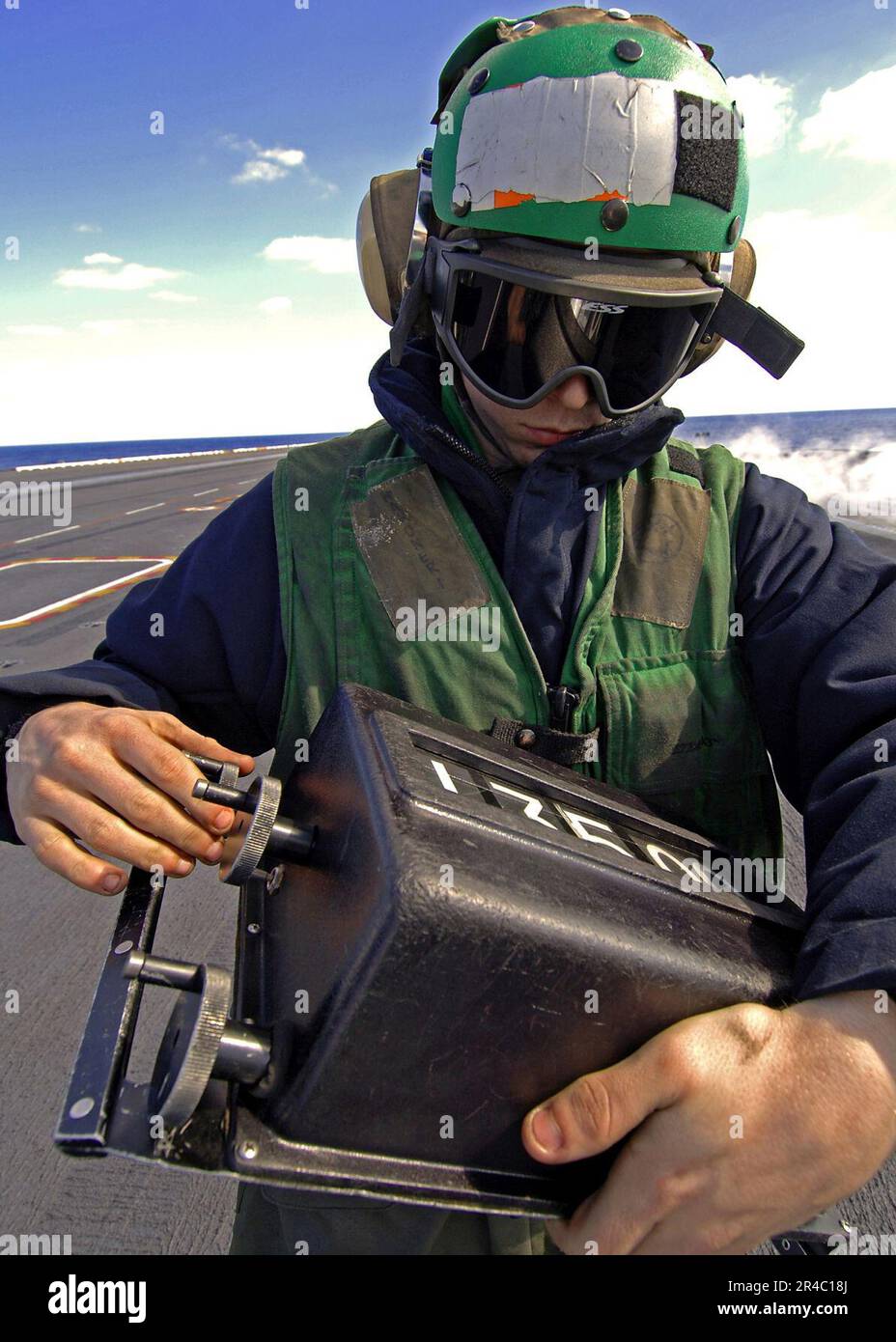 US Navy Airman adjusts a weight board on the flight deck aboard the ...
