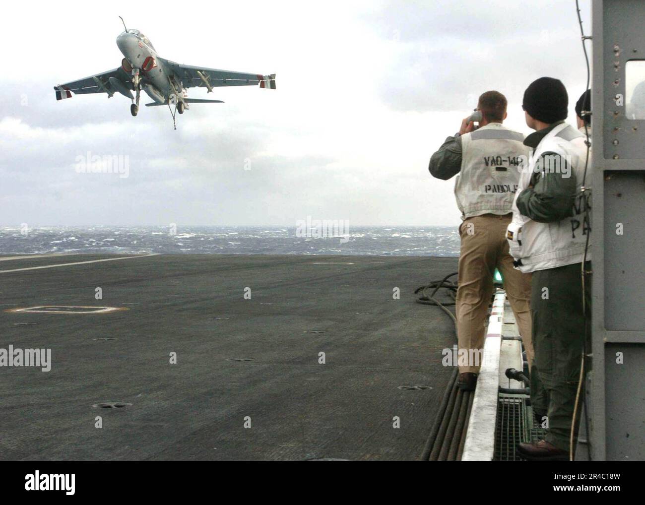 US Navy A landing signal officer observes the approach of an EA-6B ...
