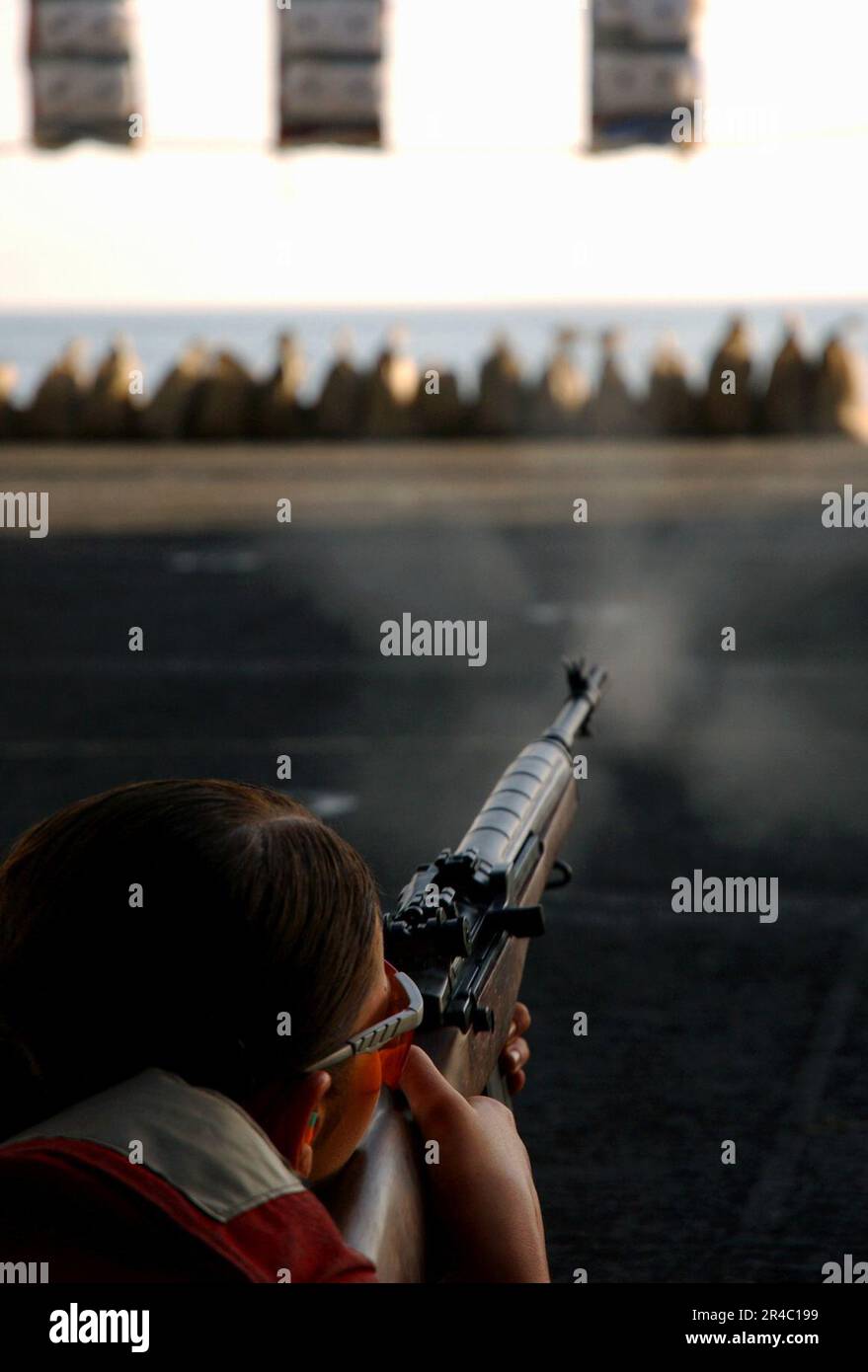 US Navy Airman fires off a round from an M-14 at a target during a ...