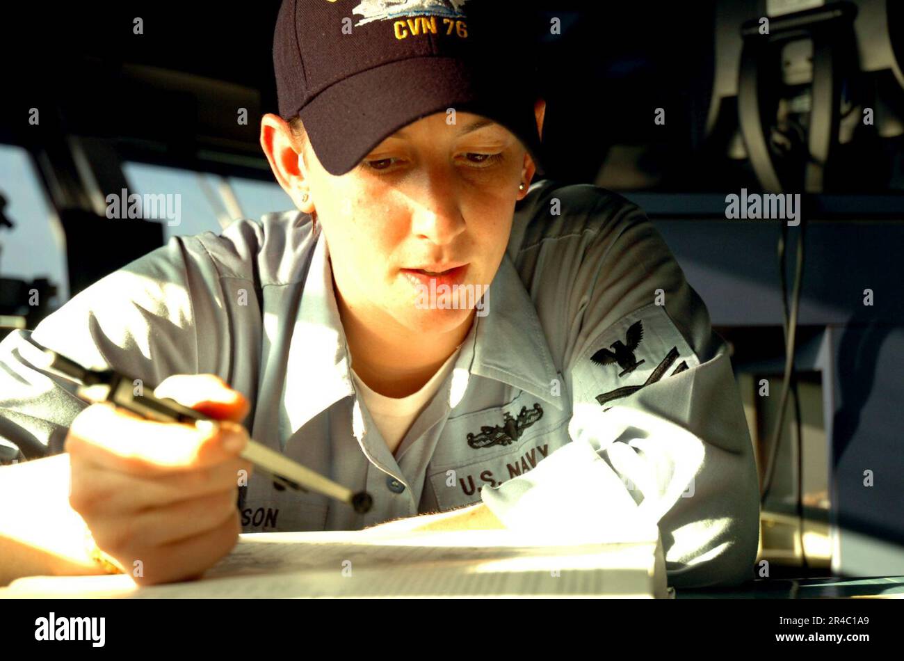 US Navy Quartermaster 2nd Class stands watch in the pilot house aboard ...
