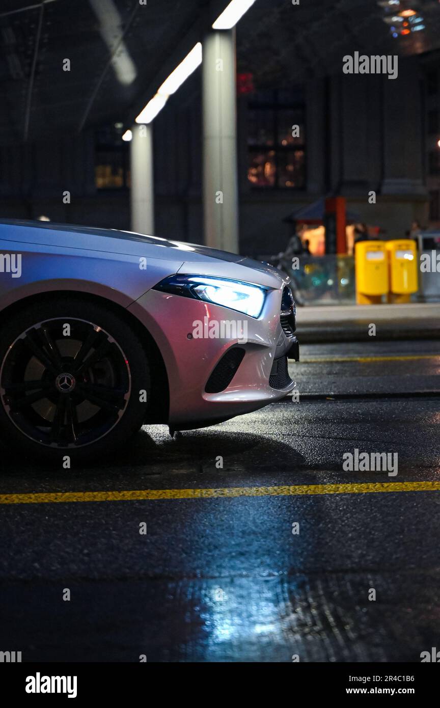 Mercedes Benz front shot at night, illuminated with red and blue lights ...