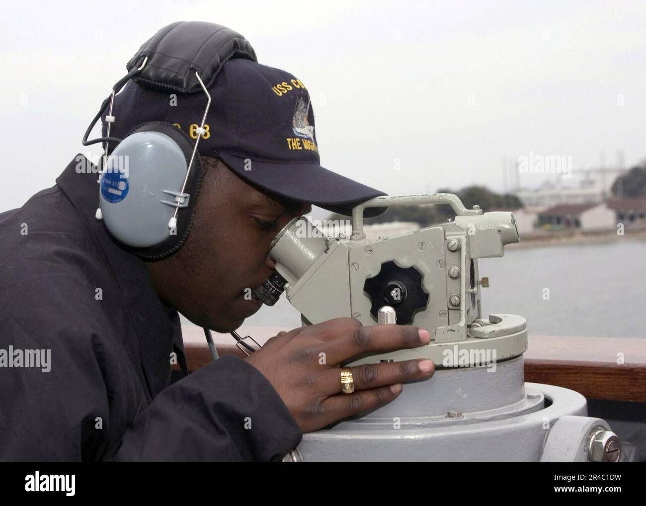US Navy Quartermaster Seaman looks through the gyro compass repeater ...