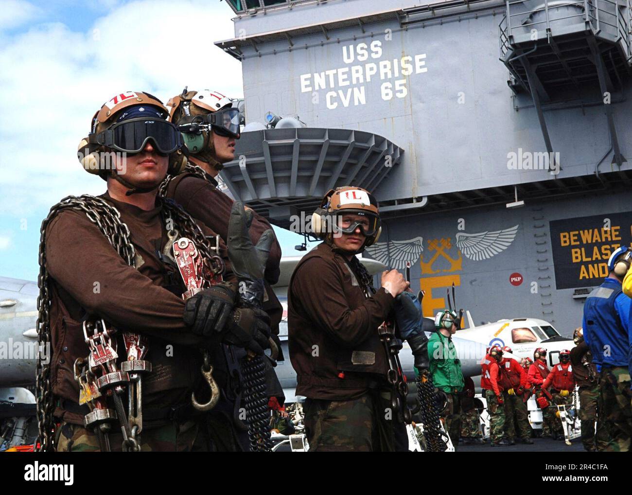 US Navy Sailors observe flight operations on the flight deck of the ...