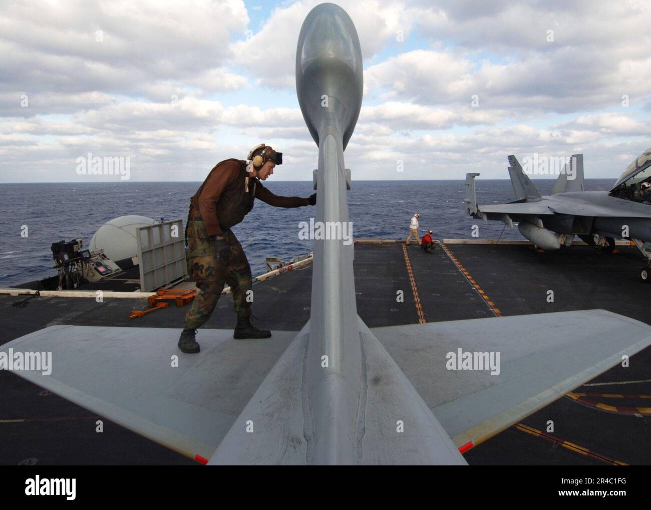 US Navy Airman inspects the horizontal stabilizers of an EA-6B Prowler ...