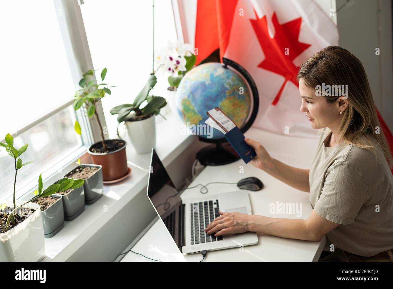 beautiful smiling woman covered in canadian flag looking at camera ...