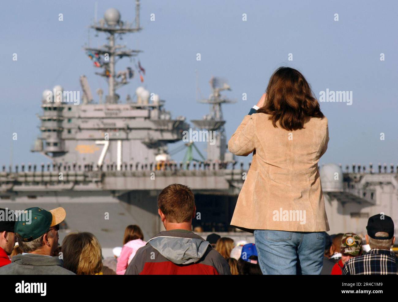 US Navy Friends and family members gather on the pier as the Nimitz ...