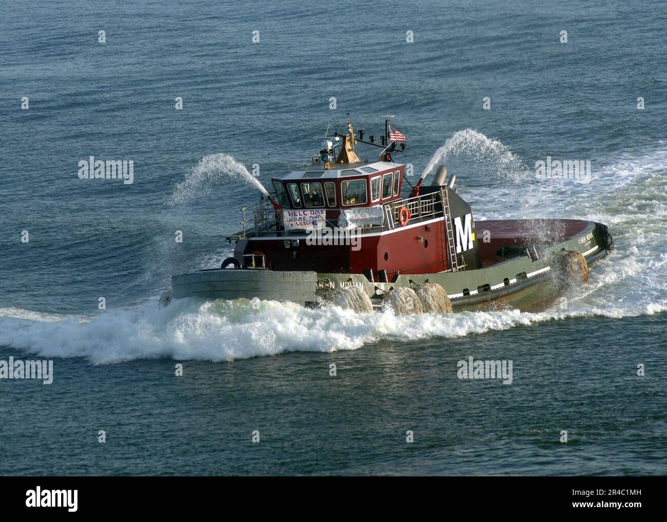 US Navy A tugboat prepares to assist the Nimitz-class aircraft carrier ...
