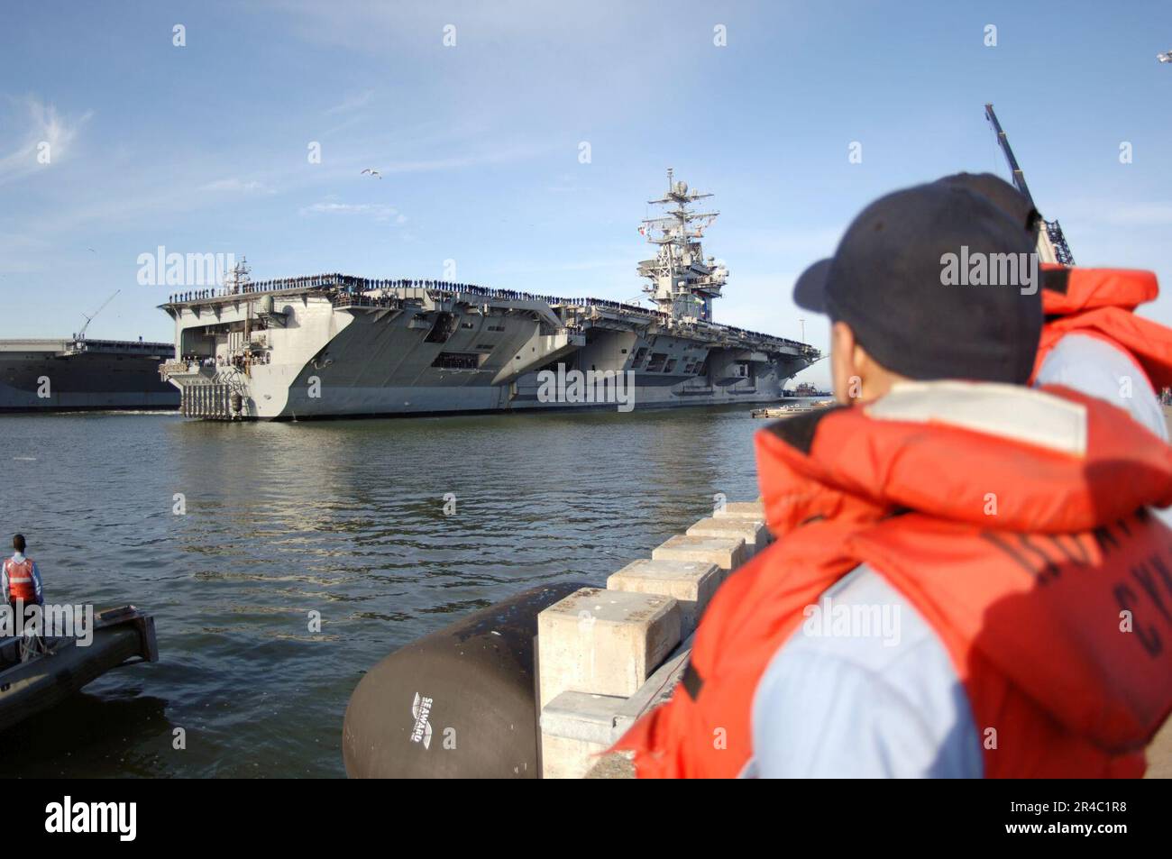 US Navy Tugboat assist the Nimitz-class aircraft carrier USS Theodore Roosevelt (CVN 71) as it ...