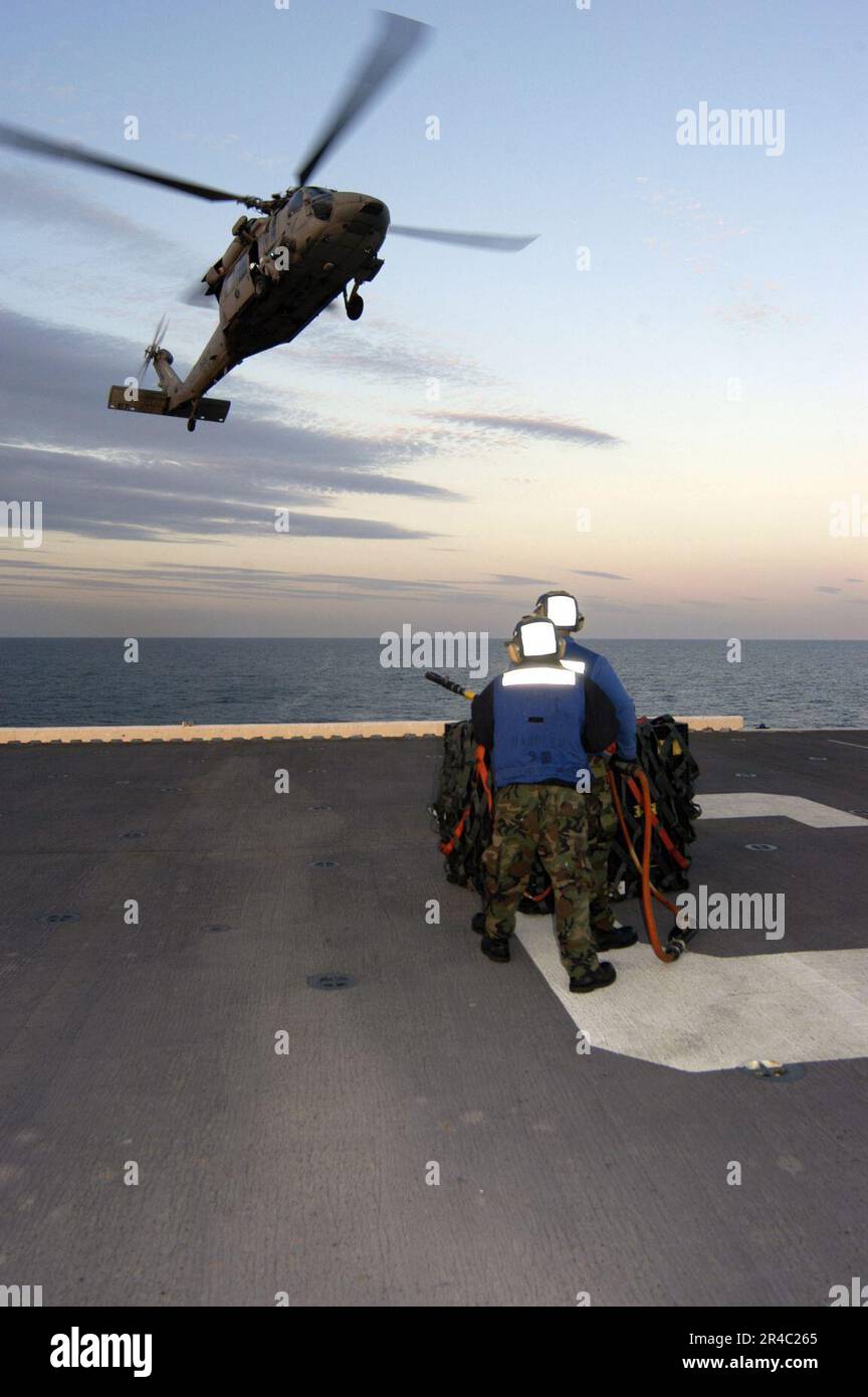 US Navy Two aircraft handlers stationed aboard the amphibious assault ...