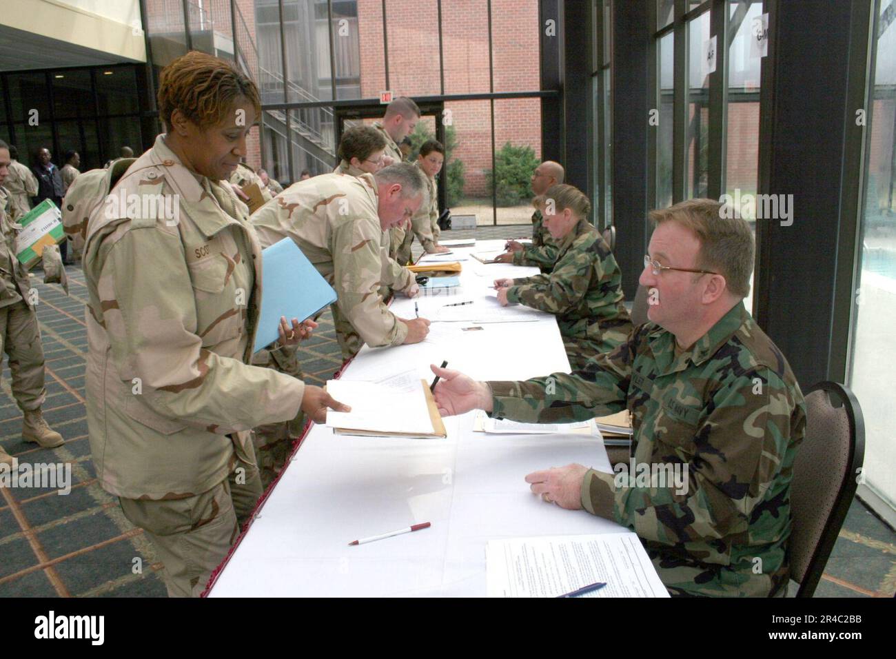 US Navy Petty Officer 2nd Class conduct her check-in with Navy ...
