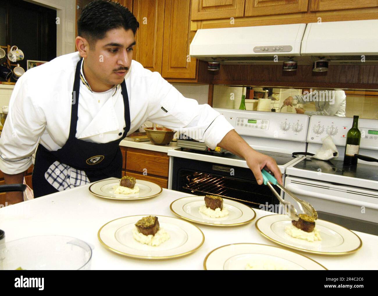 US Navy Culinary Specialist 1st Class prepares a buffet for a catered ...