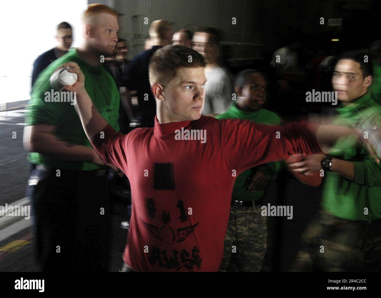 US Navy An Airman tests his accuracy in a pitching booth set up in the ...