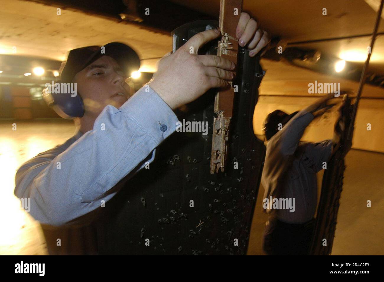 US Navy Aviation Ordnanceman hangs a replacement target in the ...