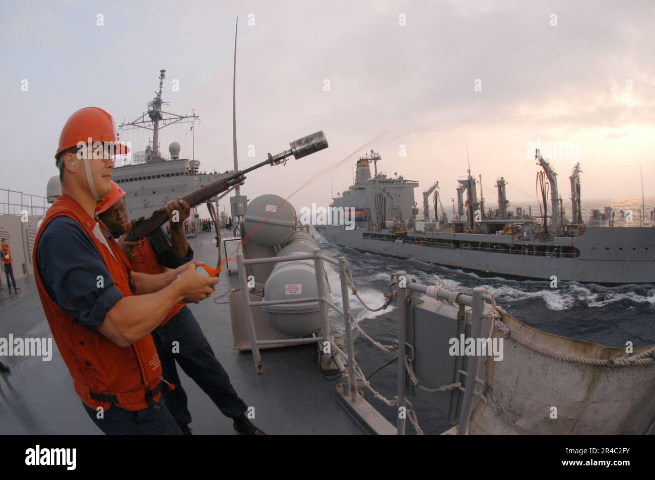 US Navy Fire Control Technician 3rd Class left, assigned to Combat ...